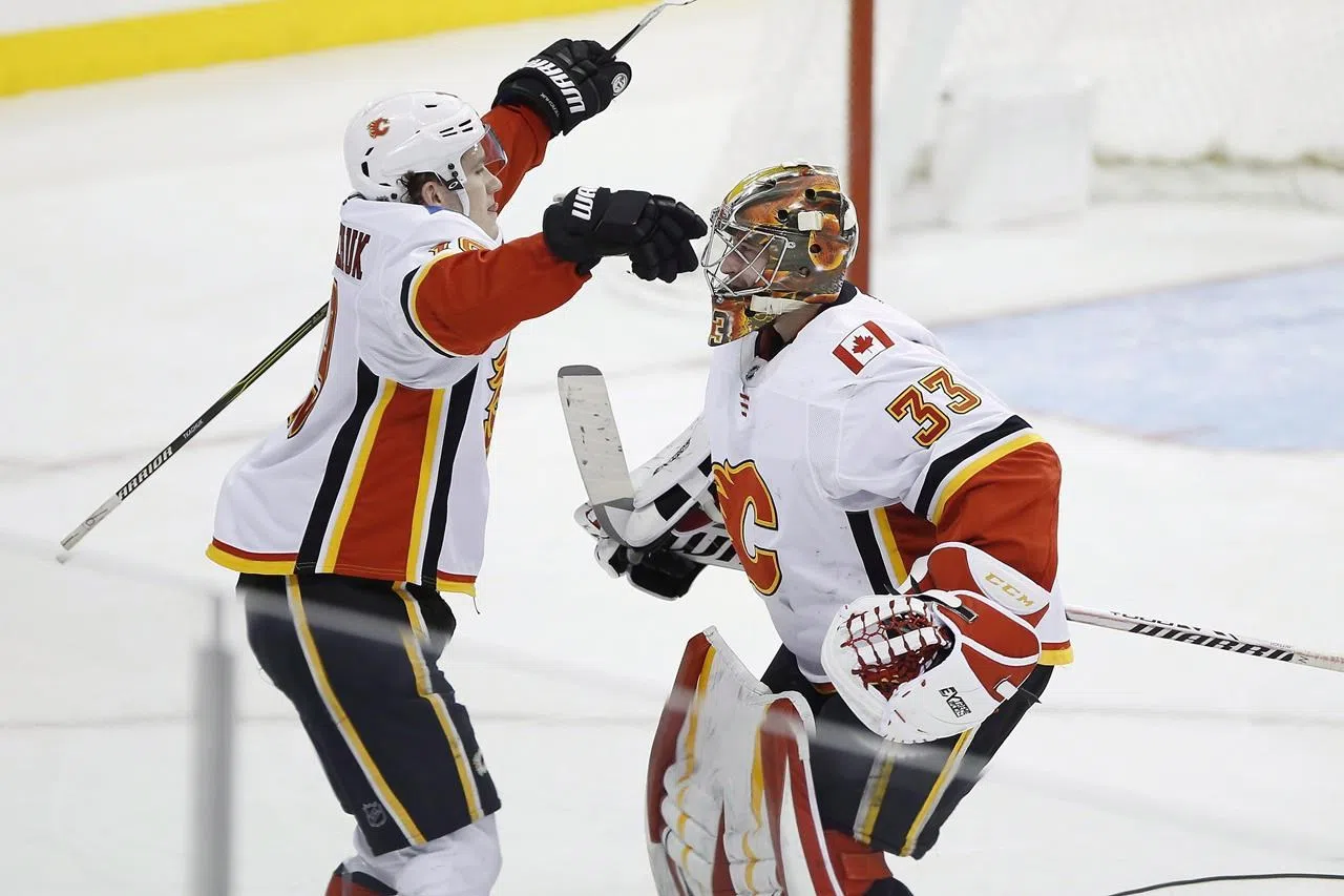 Calgary Flames goaltender David Rittich working for his wins, hugs ...