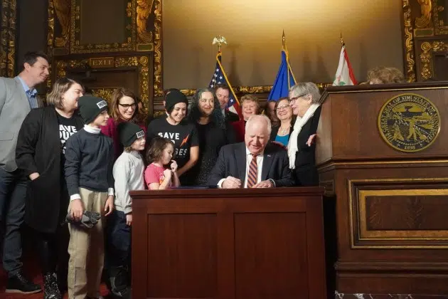 Minnesota governor signs paid family and medical leave act to give ...
