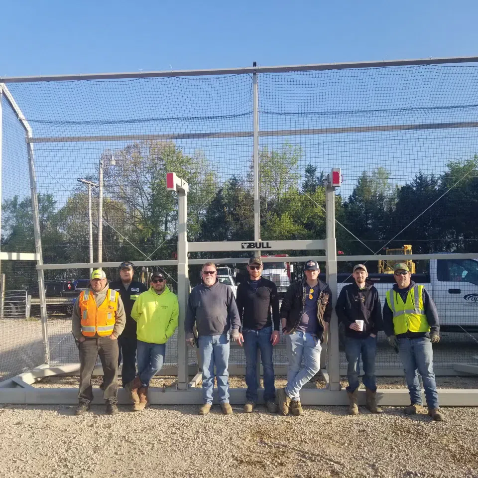 Landfill personnel installing internal fencing to reduce litter spread ...