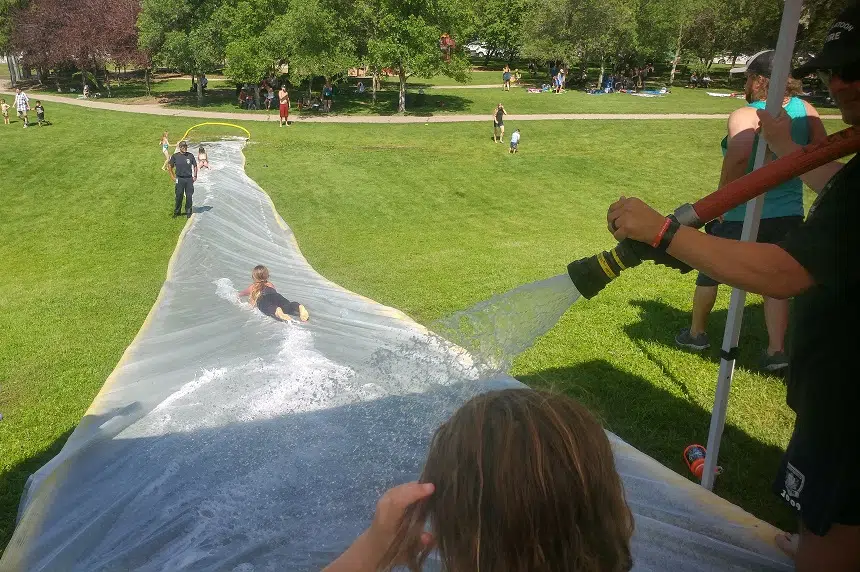 Firefighters, kids beat the heat with hydrant slip’n slide | 650 CKOM